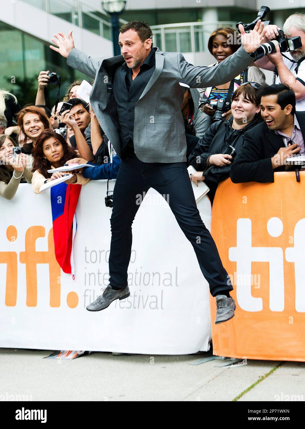 Actor Patrick Huard jumps as he poses for a photograph on the red ...