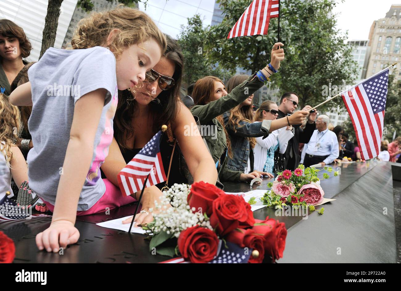 Elle Jackman,6, helps her mother, Iris Jackman, do a rubbing of her ...