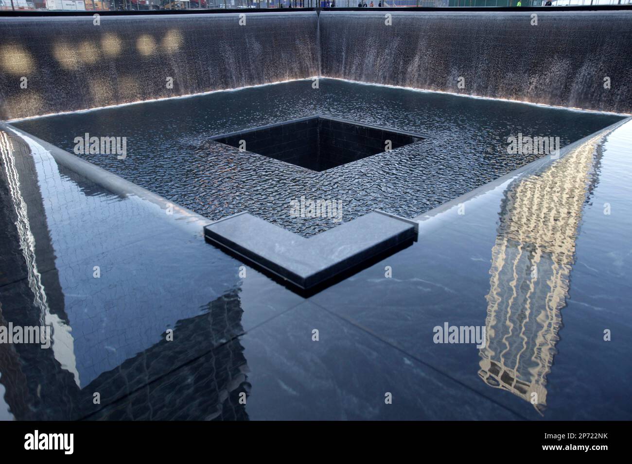 One World Trade Center is reflected in one of the memorial pools at the National September 11 ...