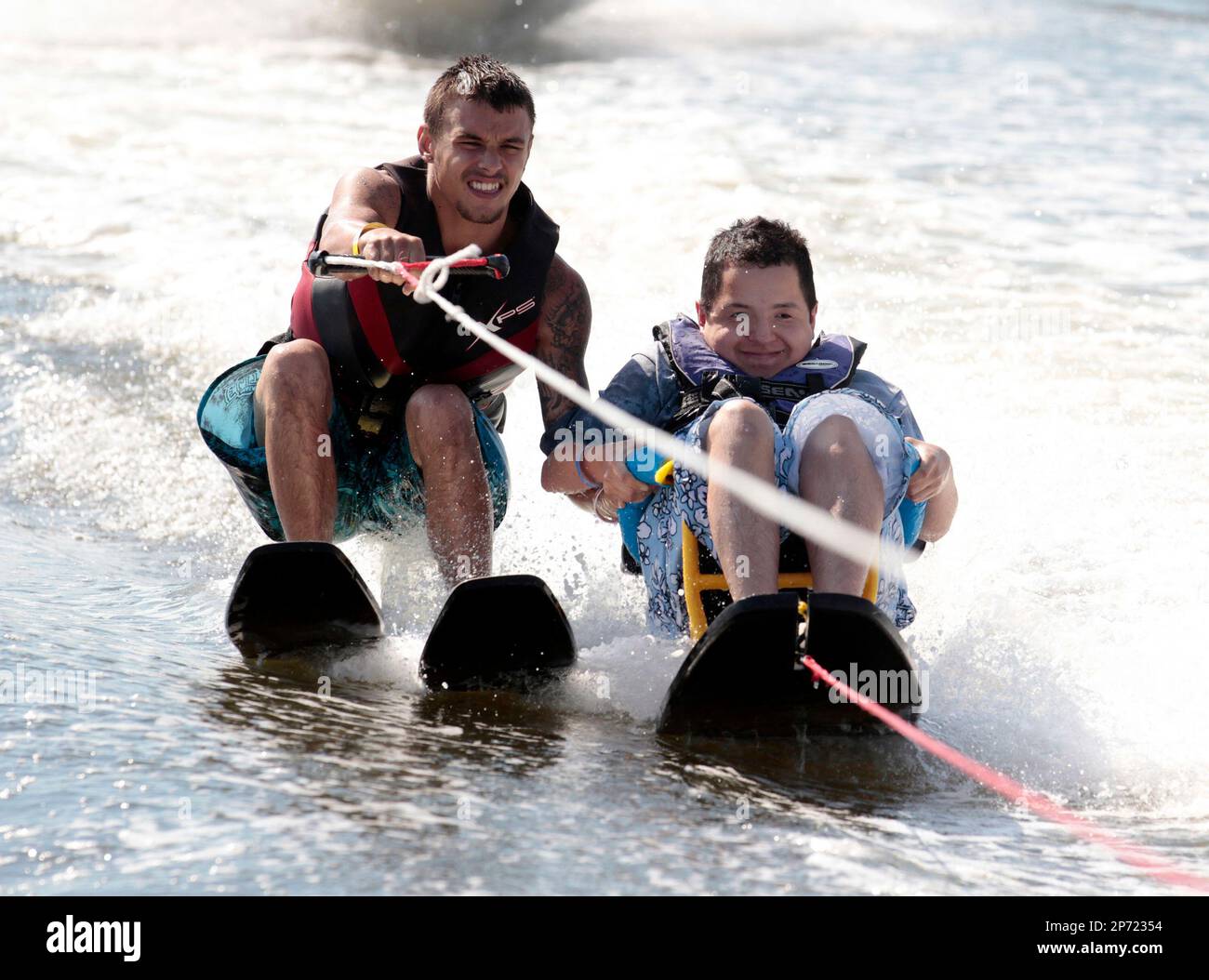 Seventeen-year-old Alec Hamilton, right, water skis behind a Texas ...