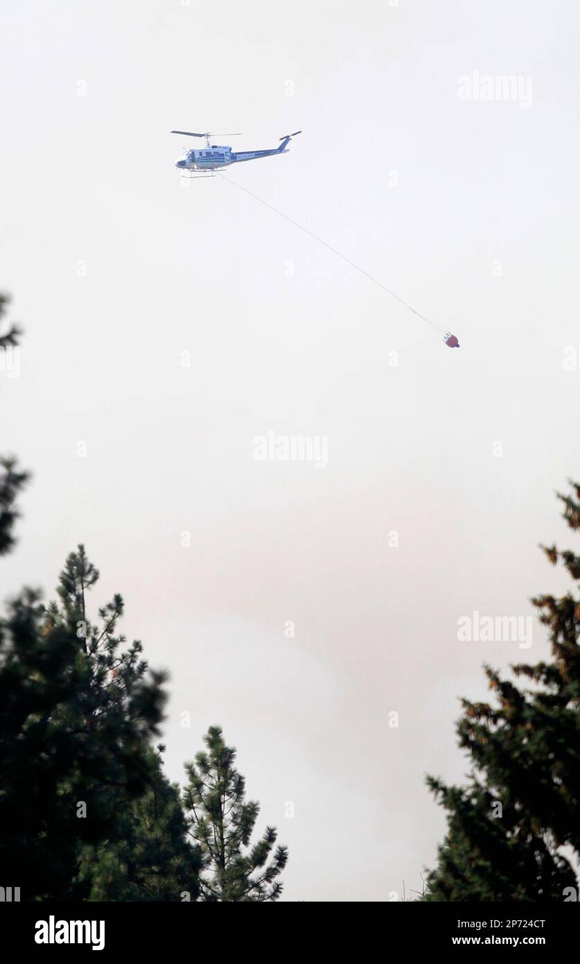 A helicpoter makes a water drop on the Monastery Complex Fire in Satus ...