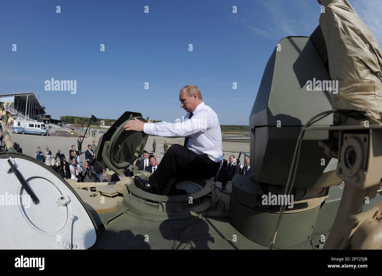 Russian Prime Minister Vladimir Putin gets in a Russian-made tank T ...