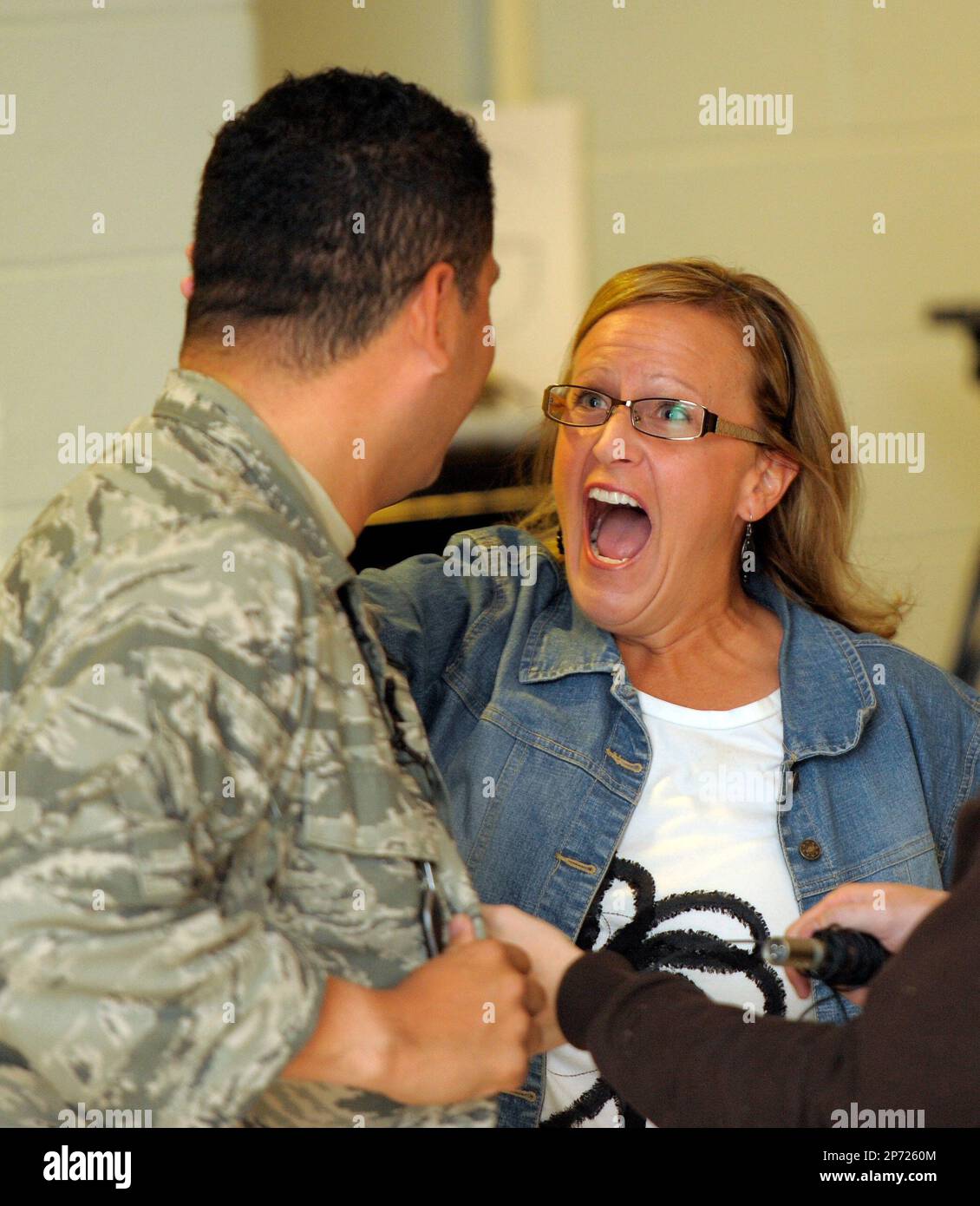 Michelle Boyle gives Air Force Staff Sergeant Mario Jimenez a hug upon ...