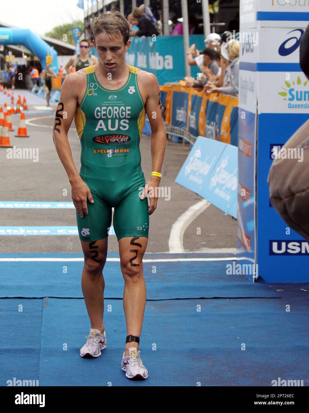 Tim George, of Australia, crosses the finish line at the 2011 ...