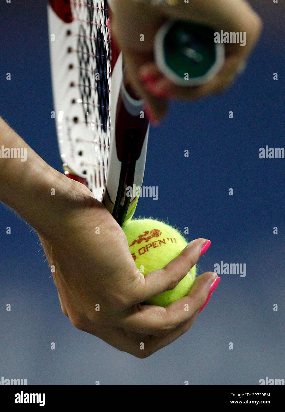 Caroline Wozniacki, of Denmark, grips the tennis ball as she prepares ...