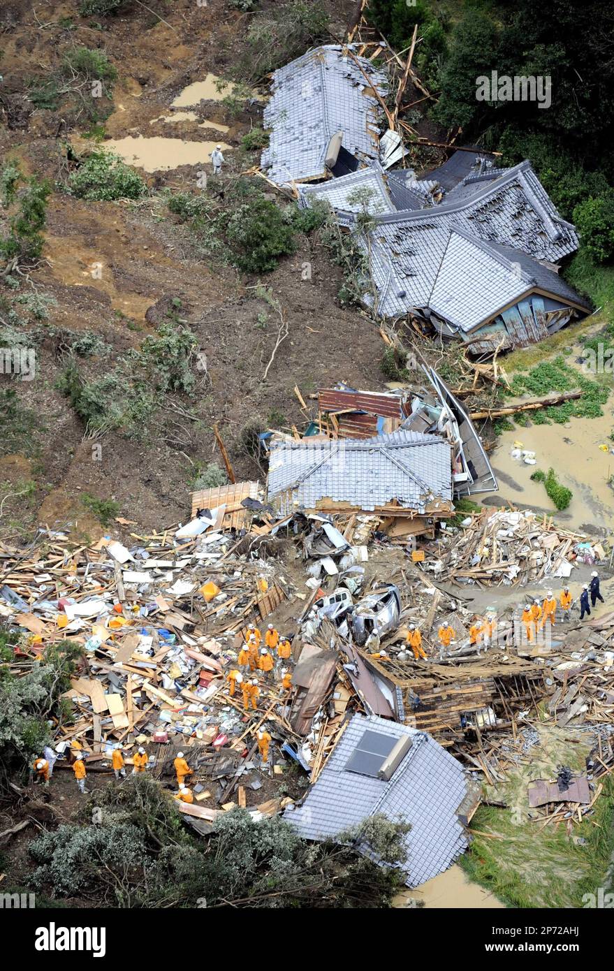 Volunteer firefighters search destroyed houses for missing people after ...