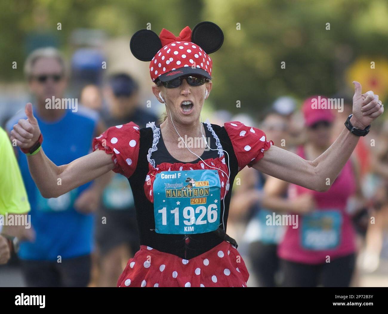 Kim Wilcox gives thumbs up as she finishes the 2011 Disneyland Half ...