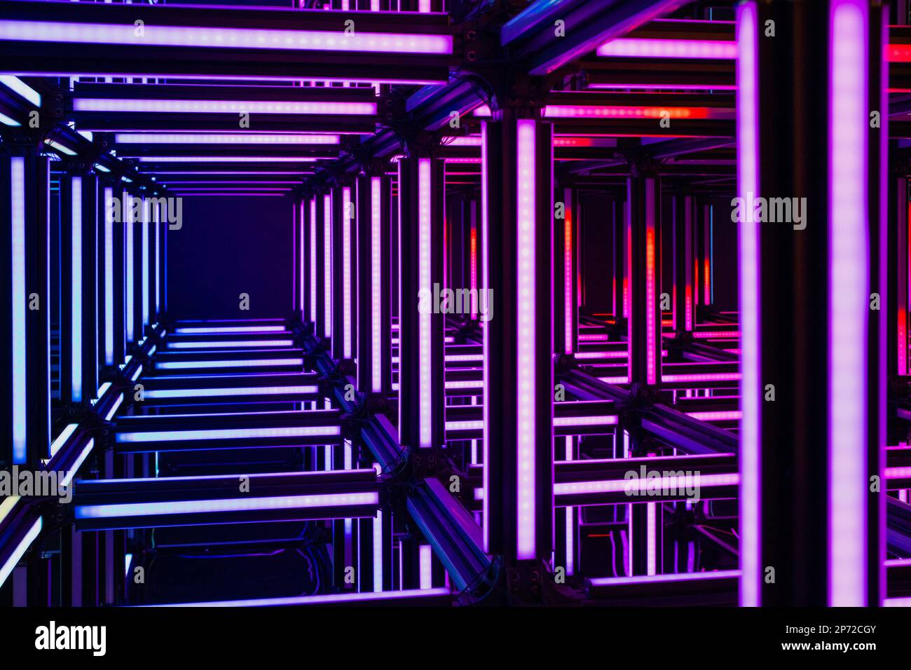 Futuristic purple, violet neon light cube art installation. Technology ...