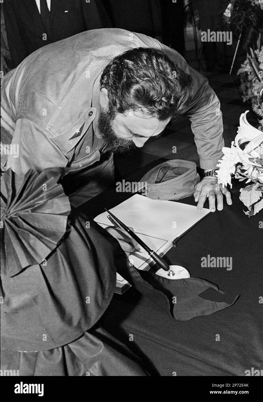 Cuban leader Fidel Castro signs the condolence book as he attends the ...