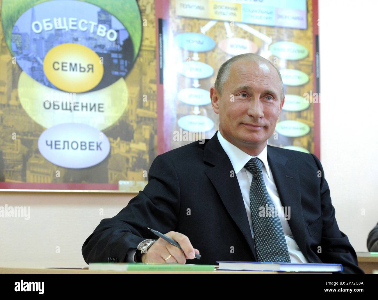 Russian Prime Minister Vladimir Putin attends a lesson as he visits a ...