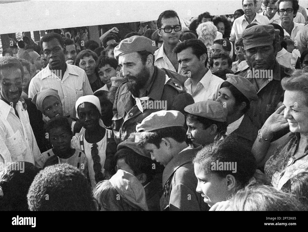 Cuban leader Fidel Castro, center wearing a beret, talks to students ...