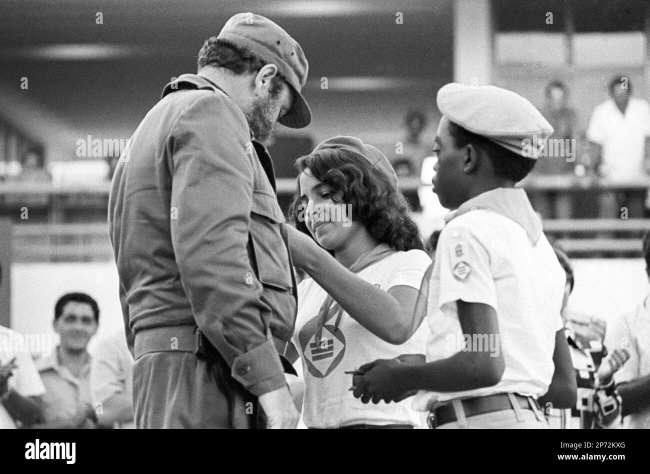 Students give Cuban leader Fidel Castro, left, a gift during the ...