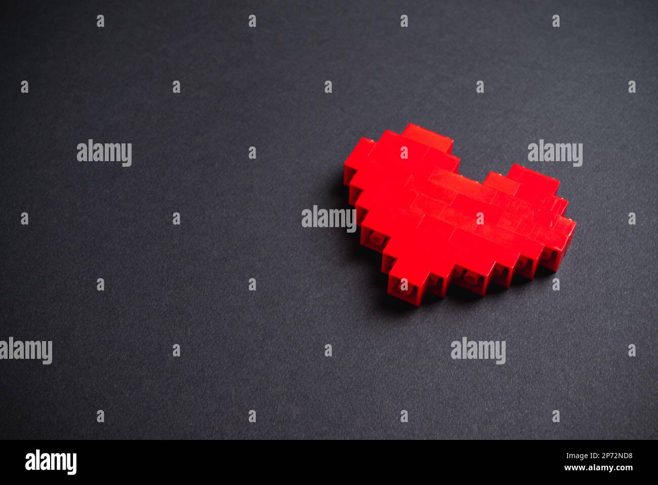 Red heart made of plastic bricks on a dark gray background Stock Photo ...