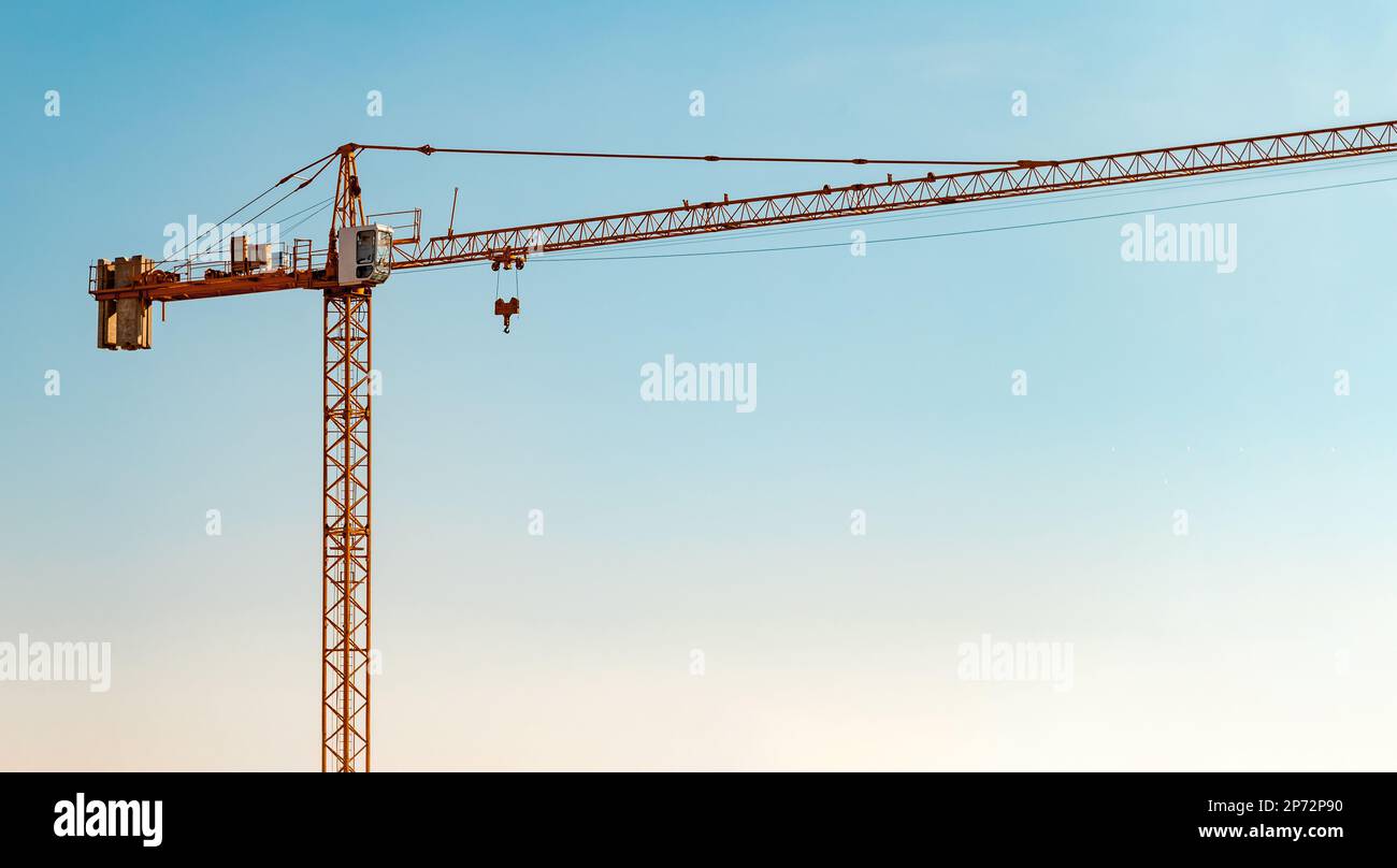 Construction crane in front of cloudless sunny blue sky Stock Photo - Alamy