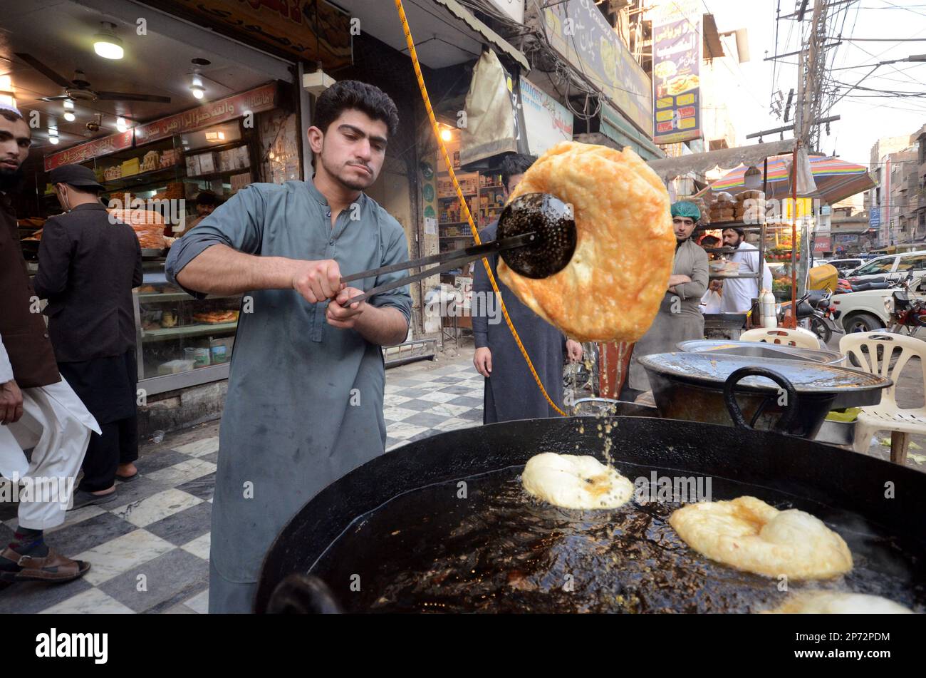 Peshawar, Pakistan. 07th Mar, 2023. Vendors at a stall in the Qissa ...