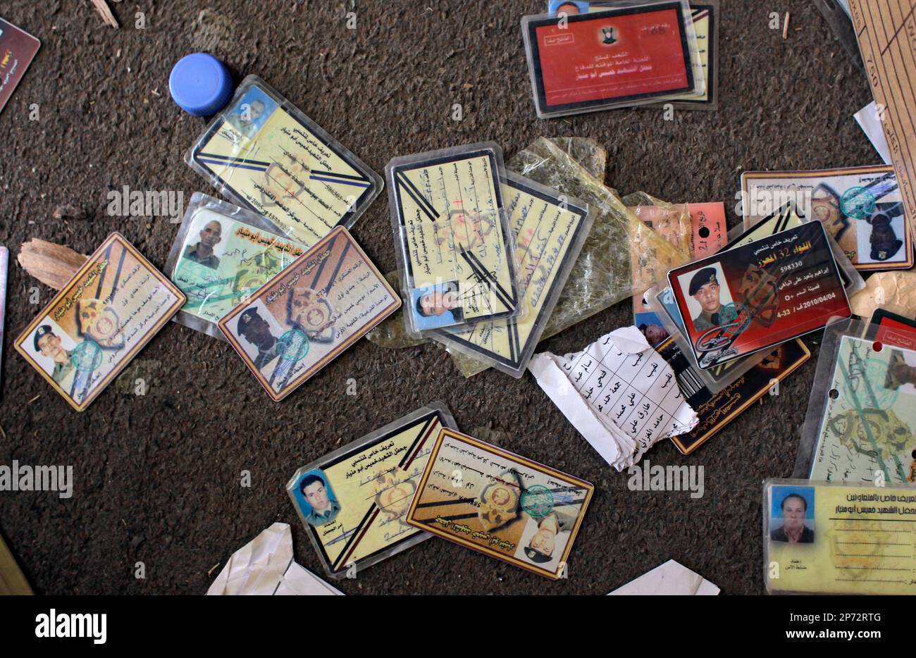Military identification cards are seen on the floor in the headquarters ...
