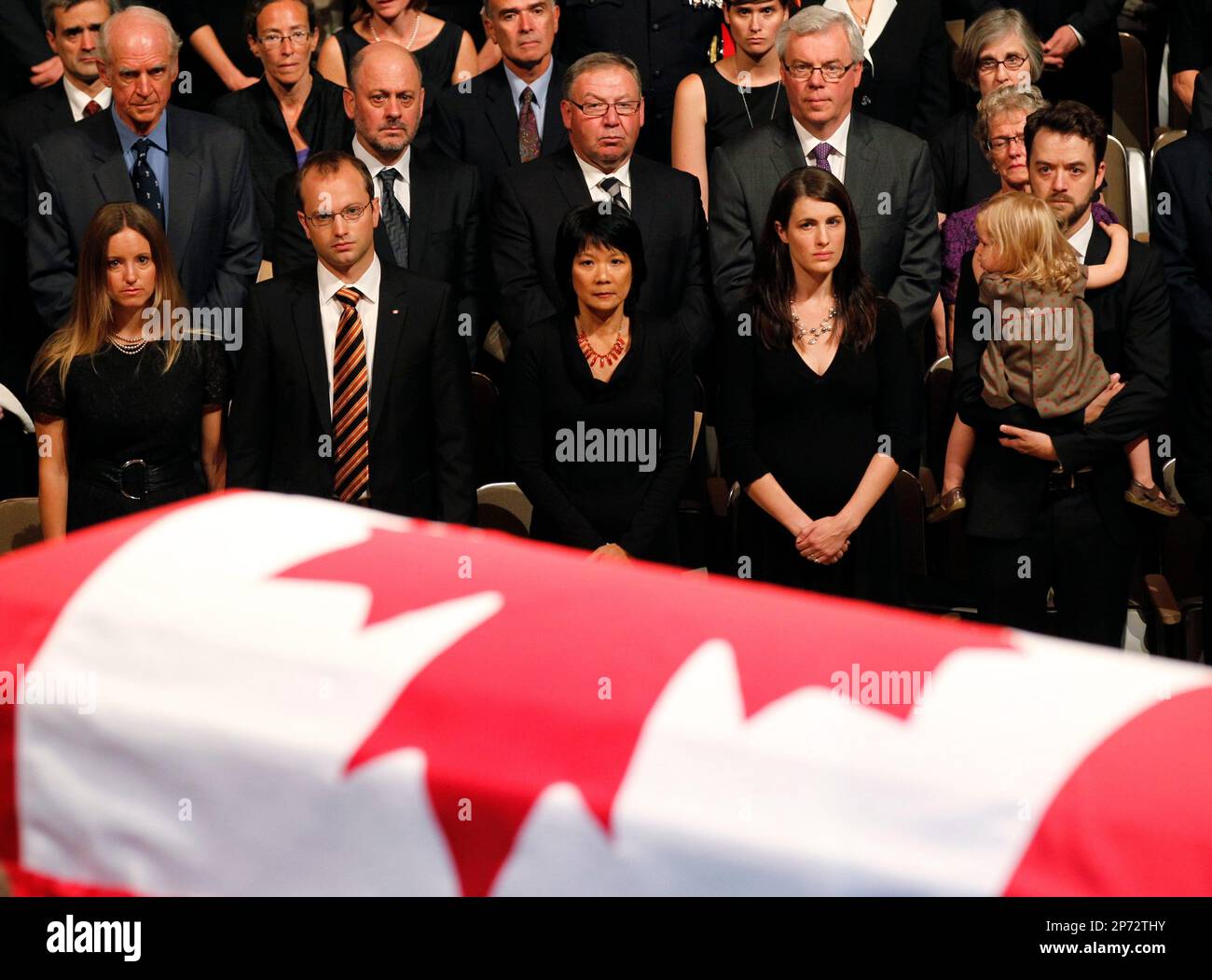 Family members watch as the coffin of the late New Democrats party ...