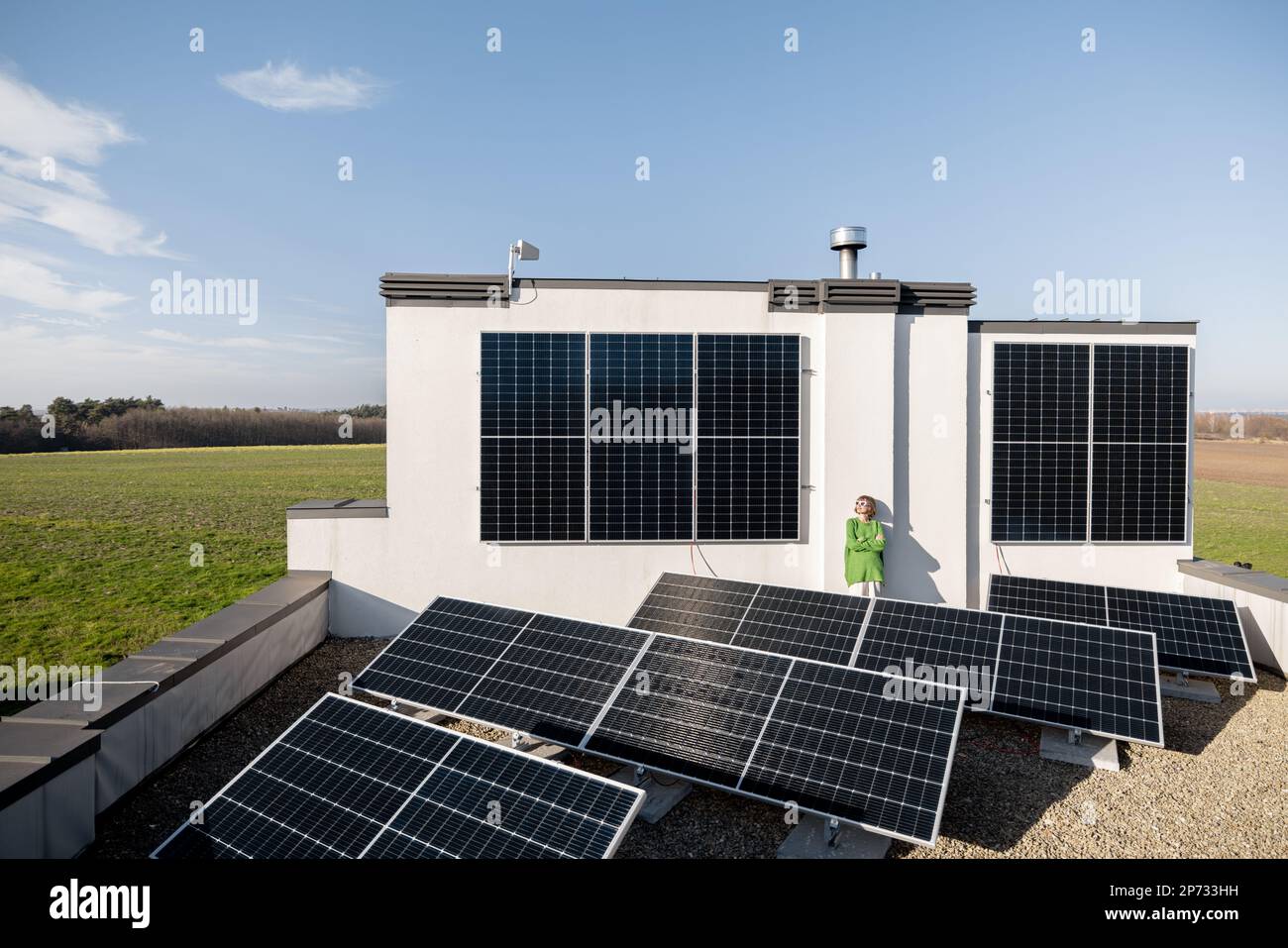 Solar power plant installed on rooftop with a woman owner Stock Photo ...
