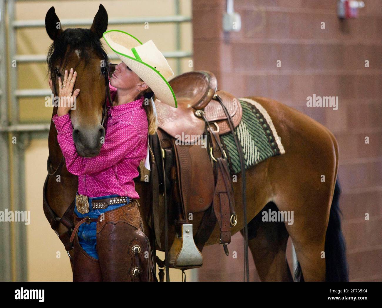 Becky Englert, of Elk Mountain, hugs her wild horse, Balder, before ...