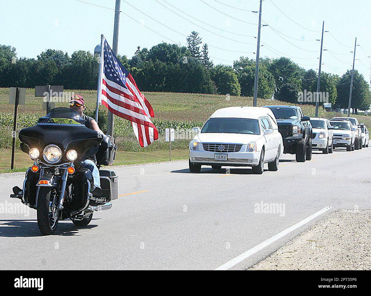 The hearse containing the body of U.S. Navy Seal Jon Tumilson makes its way to the cemetery ...