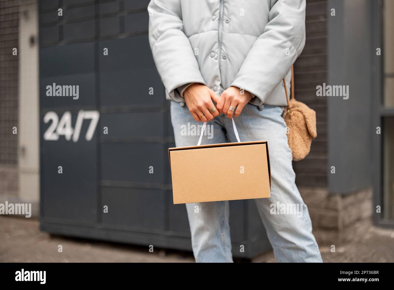 Holding a parcel on background of automatic post office machine Stock ...