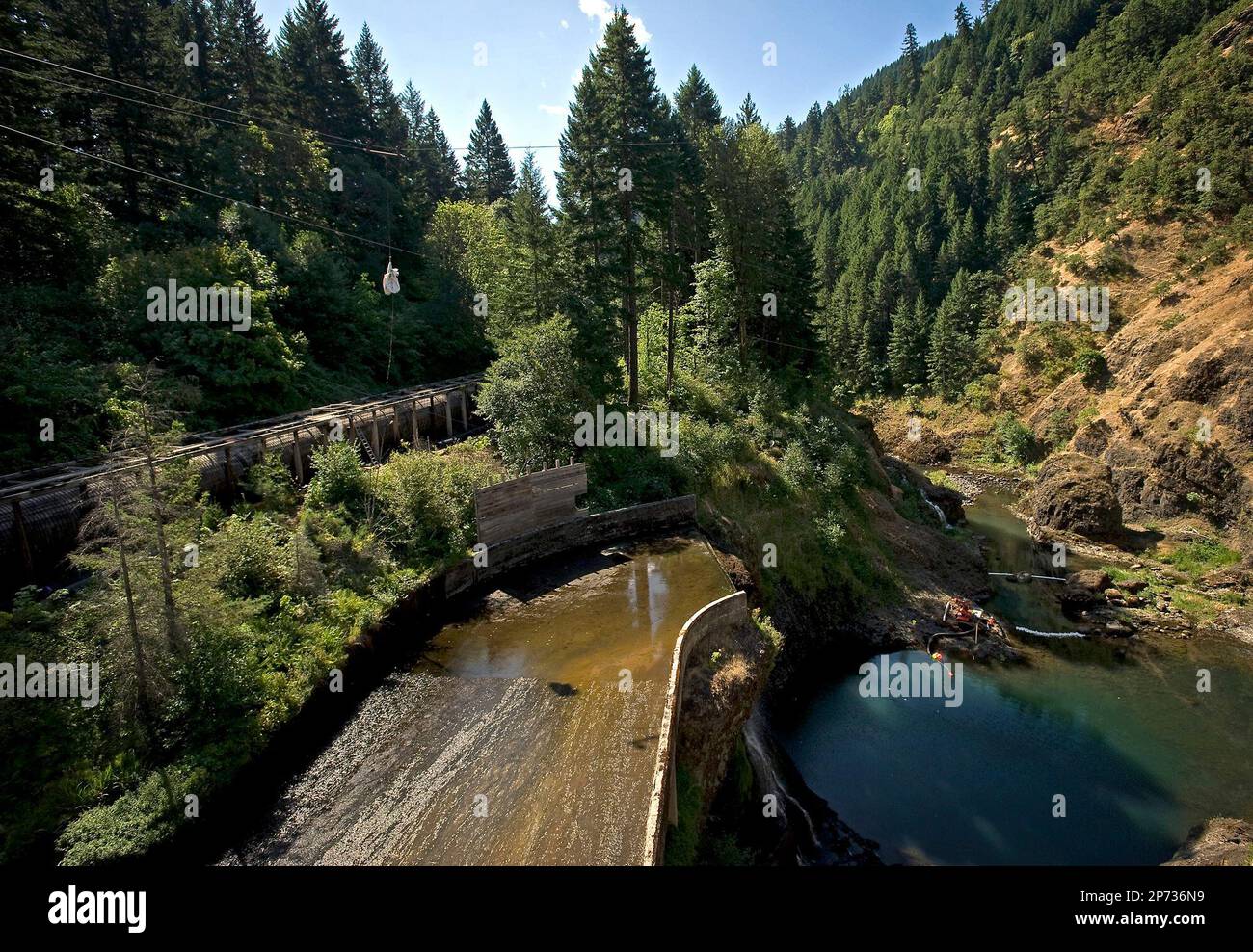 Workers at the base of Condit Dam prepare to begin drilling and ...