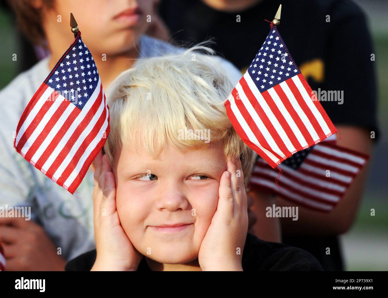 Conrad Proctor, 7 and a Joplin, Mo., second grader, holds U.S. flags on ...