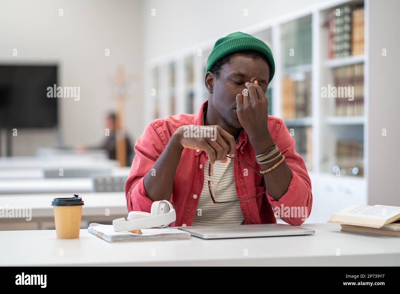 Stressed tired student black guy feels exhausted sit at lecture ...