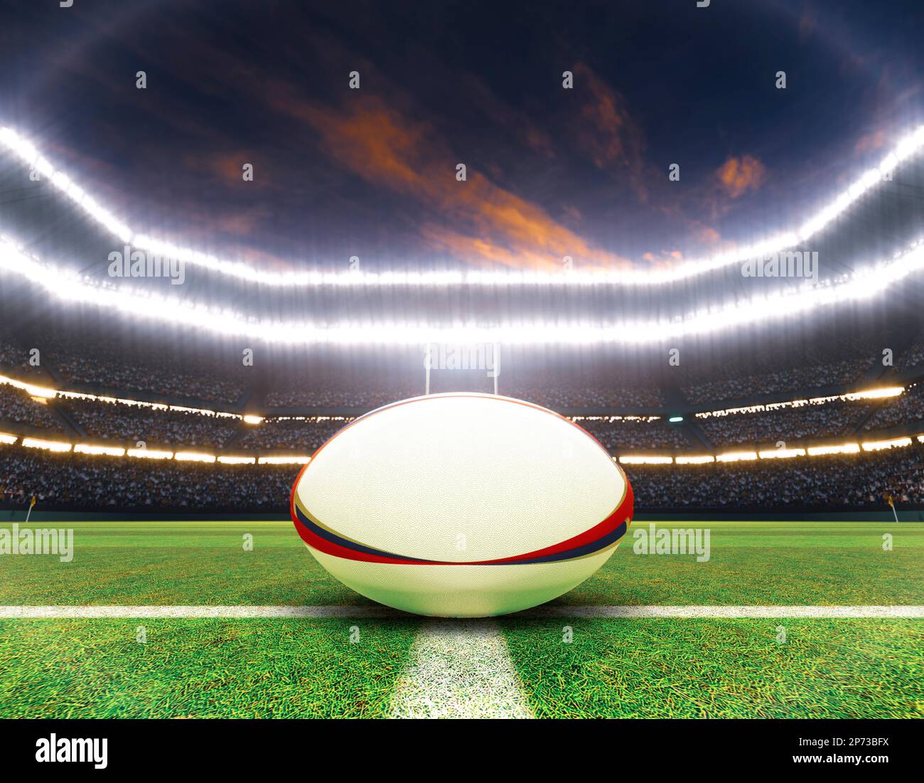 A rugby ball on the centre line of a rugby stadium with posts on a ...