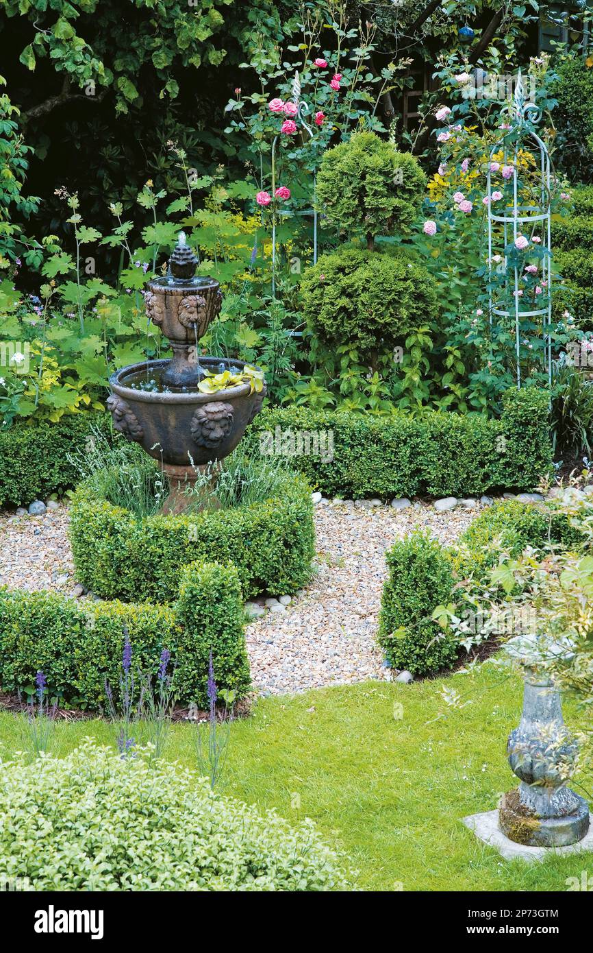 ornamental water feature with box hedging Stock Photo - Alamy