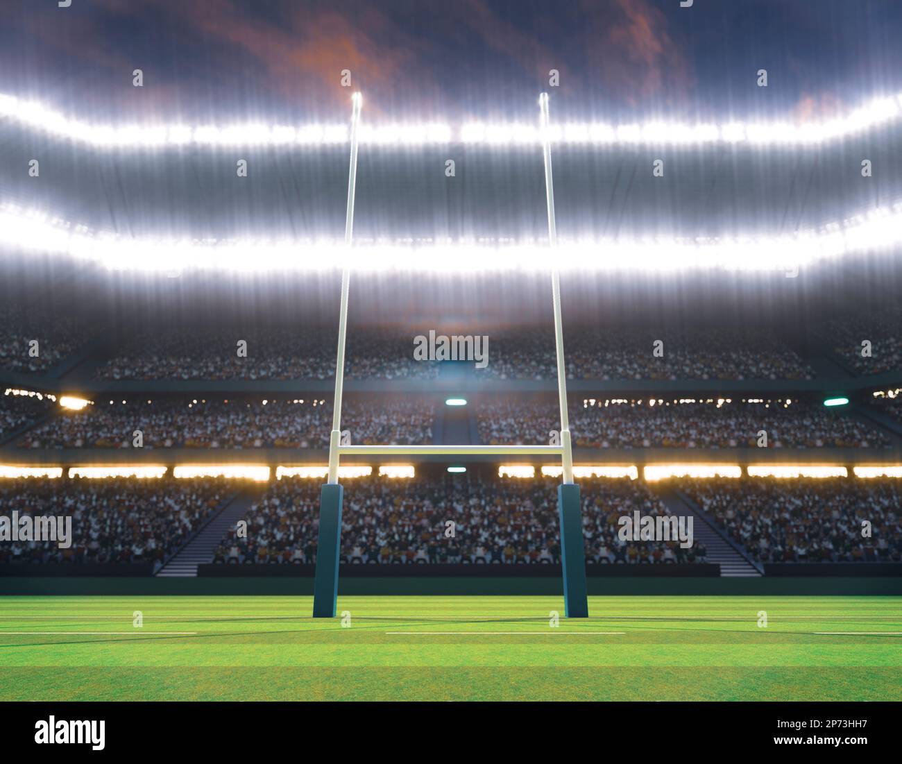 A rugby stadium with posts on a marked green grass pitch at night under ...