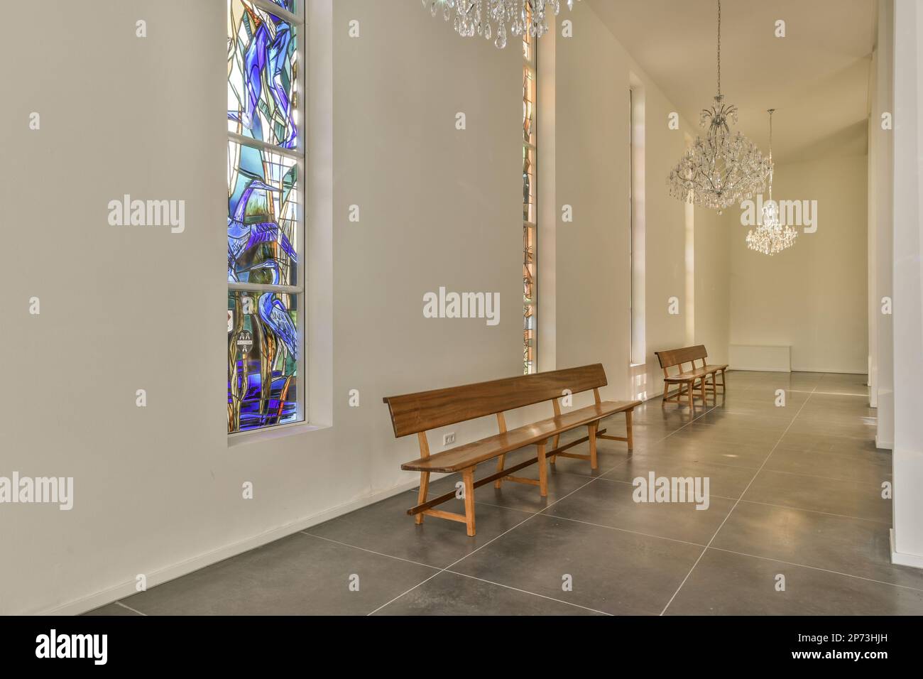 the inside of a church with stained glass windows and benches on either ...