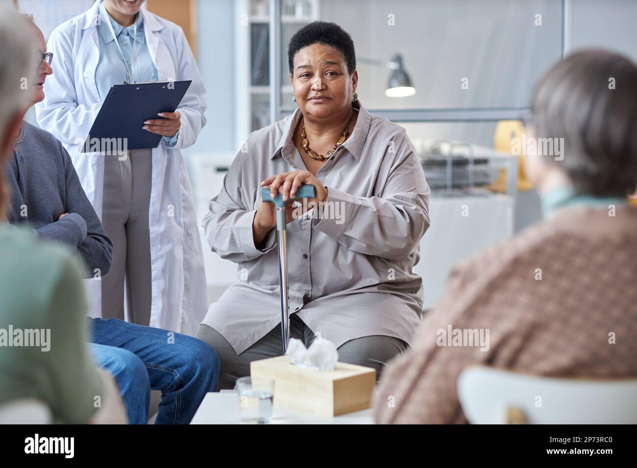 Portrait Of Black Senior Woman Sharing With Mental Health Support Group