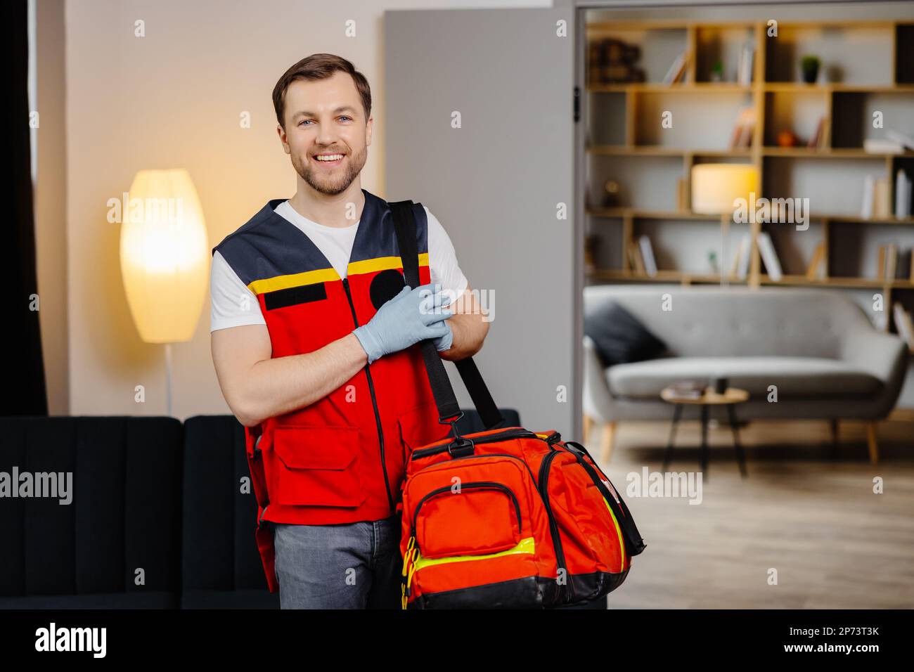 First aid course. A young male paramedic with a bag on his shoulders is ...