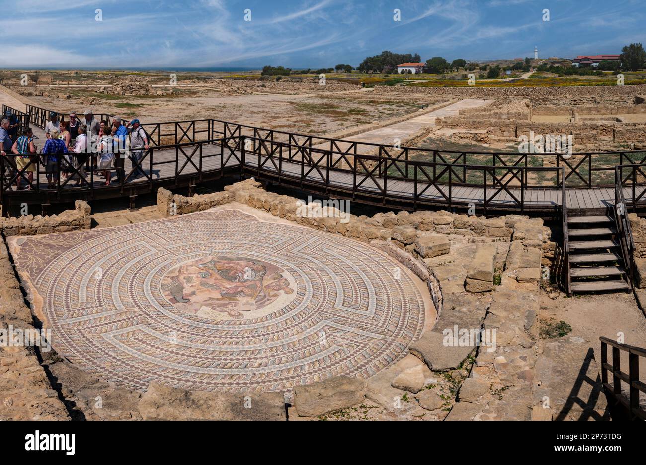 Tourists admiring the Theseus Mosaic at Paphos Archaeological Park ...