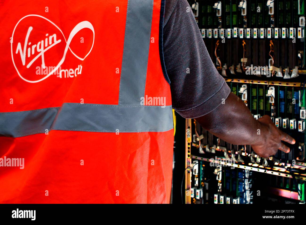 A Virgin Media engineer connecting a house to the Virgin telephone ...
