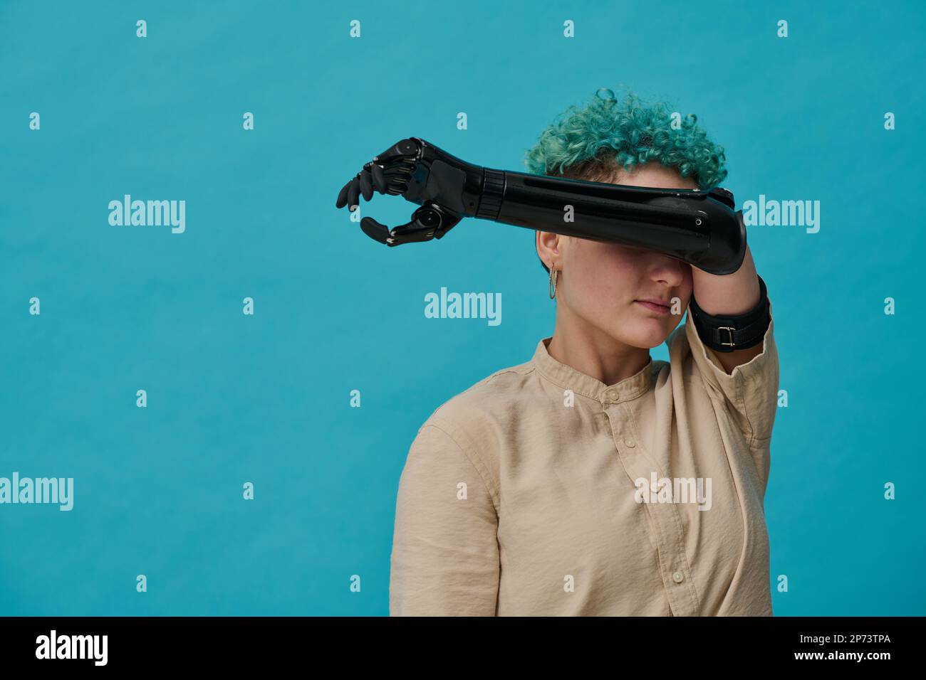 Portrait of young girl with prosthetic arm in depression standing ...