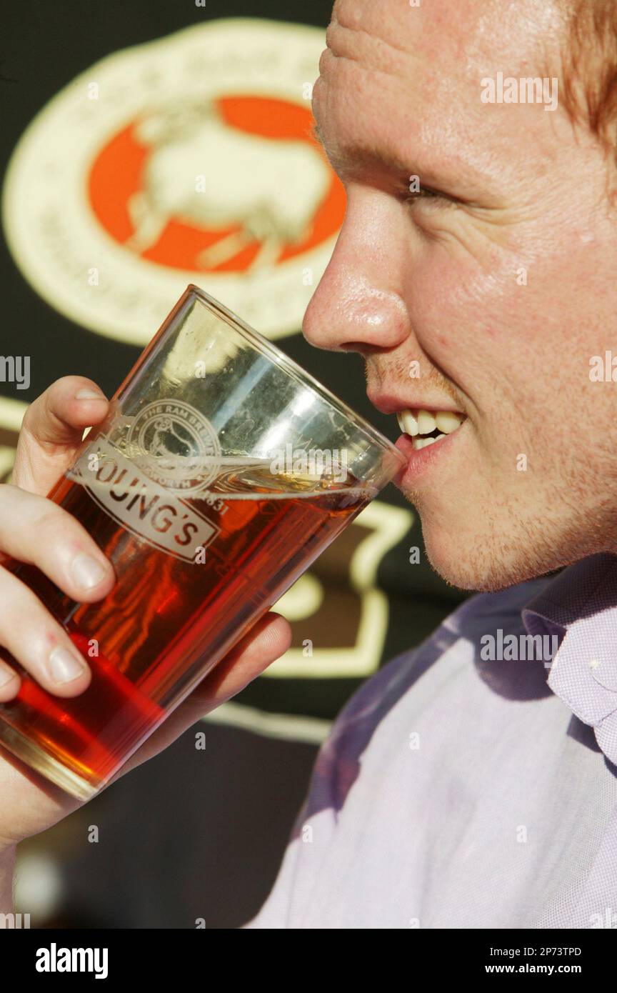 A person drinking a pint of beer at a Young & Co's Brewery. (Newscast ...