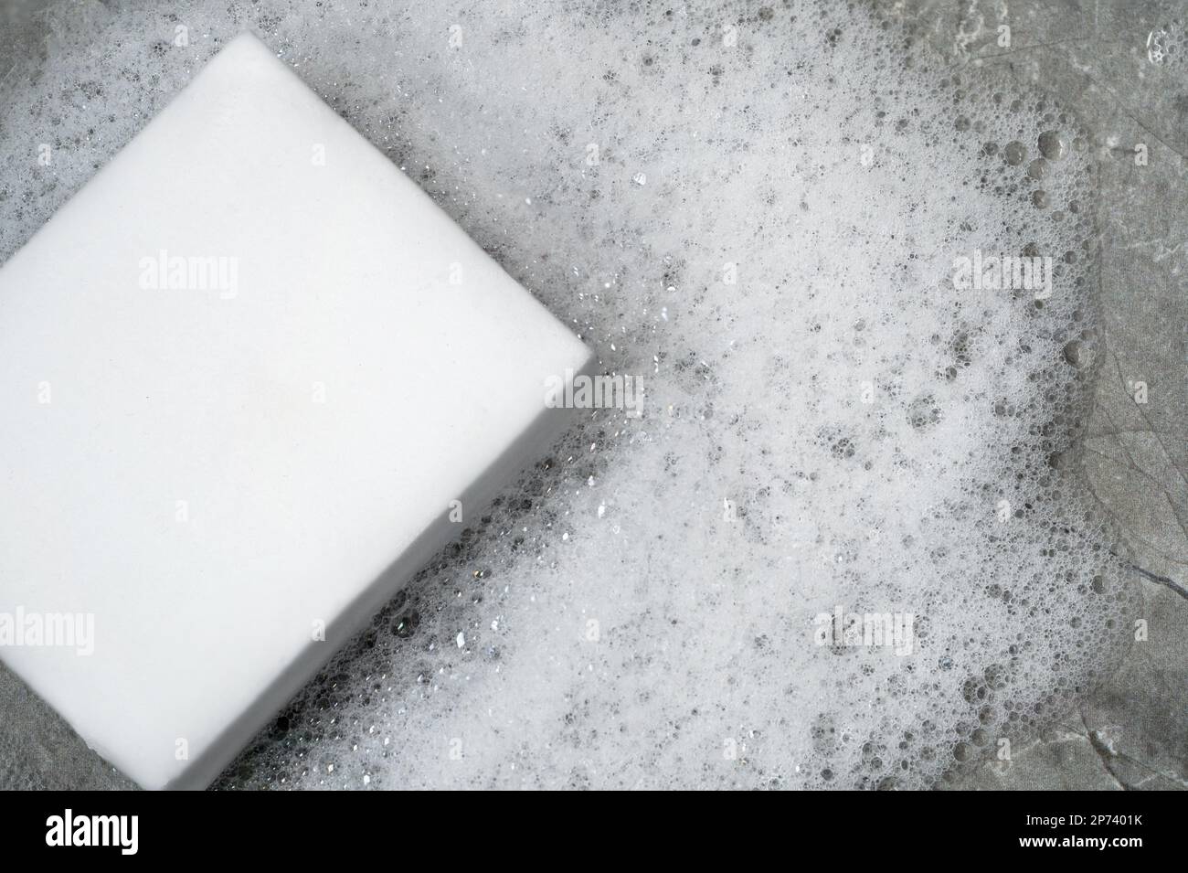 Close up photo white sponge and foam or soap bubbles as a symbol of ...