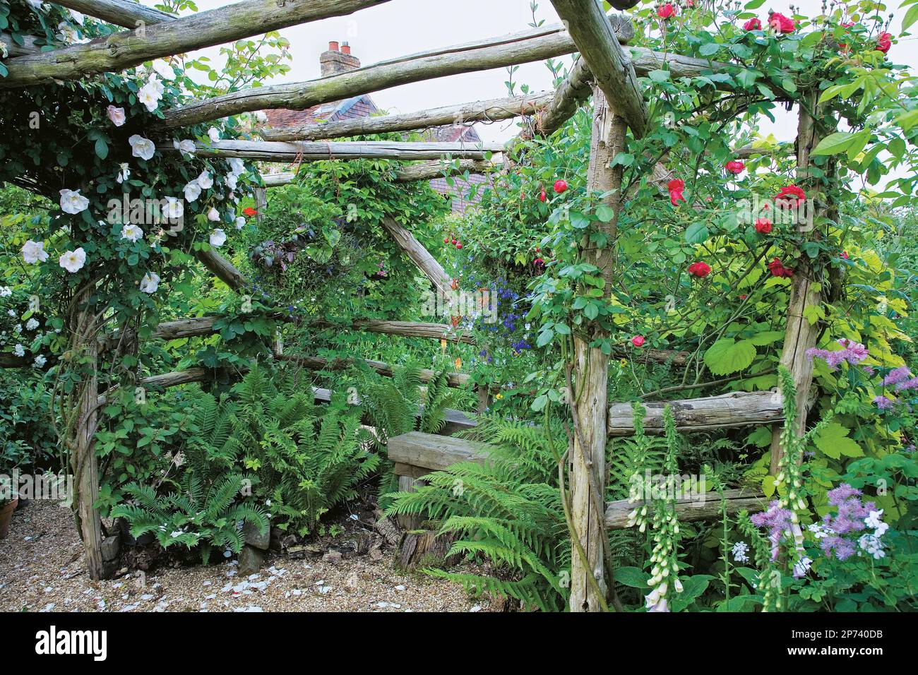 Rustic pergola in cottage garden Stock Photo - Alamy