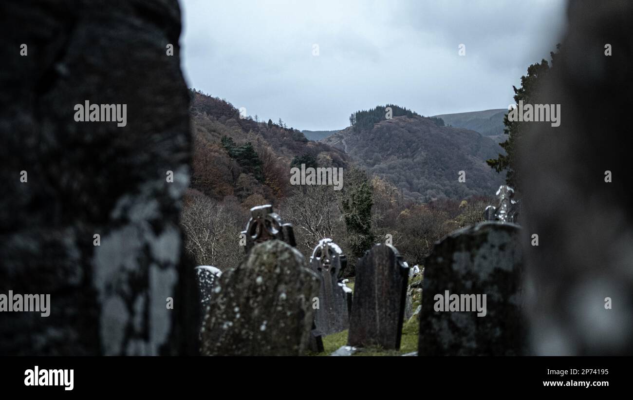 Graveyard with moody atmosphere of a graveyard nestled in the mountains ...