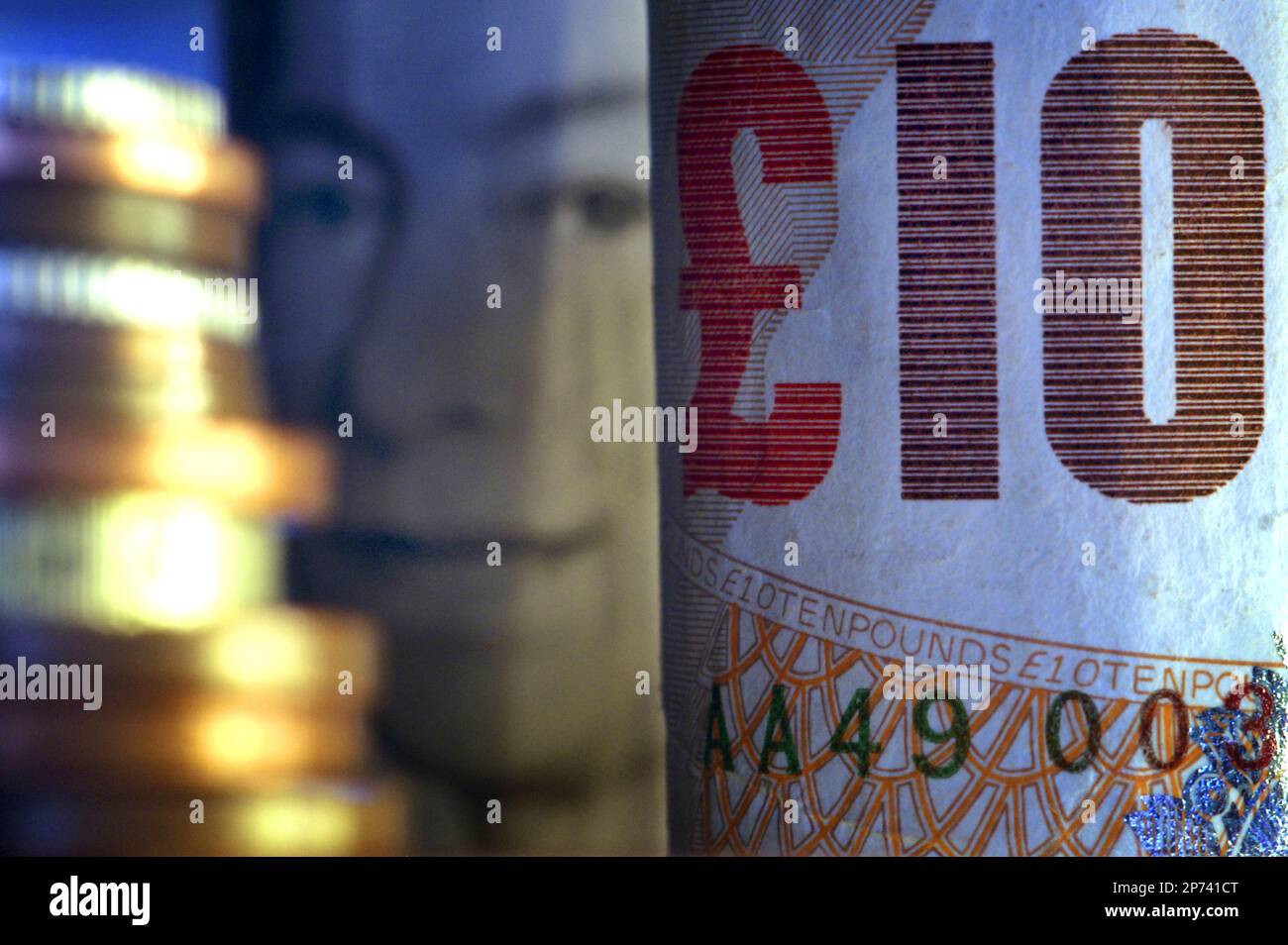 Close-up picture of ten pound notes and a stack of Britsh sterling ...