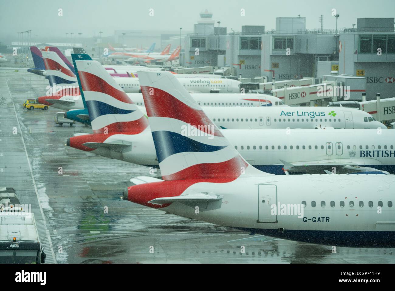 London, UK. 8 March 2023. Commercial airlines at the gates during heavy ...