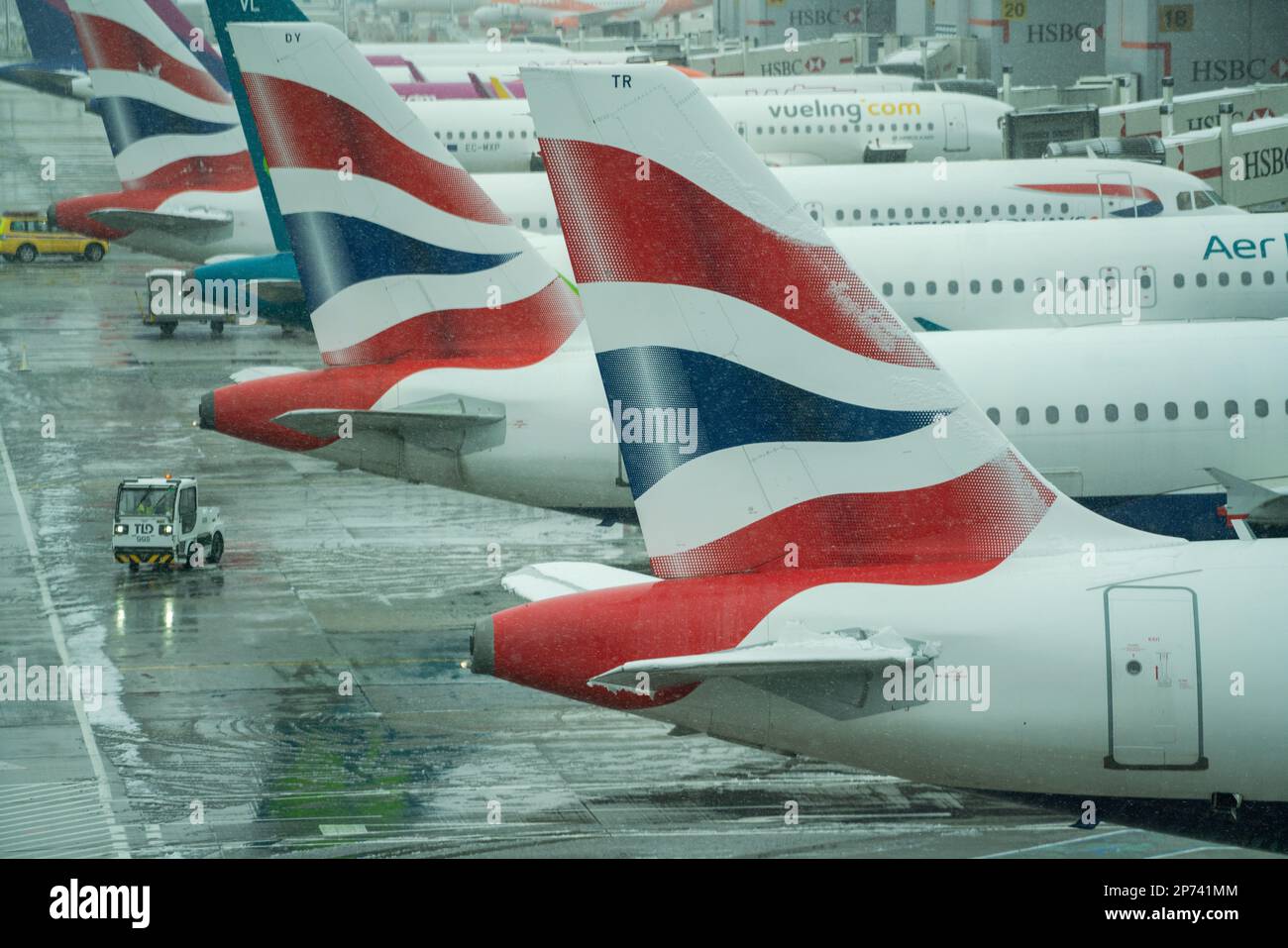 London, UK. 8 March 2023. Commercial airlines at the gates during heavy ...