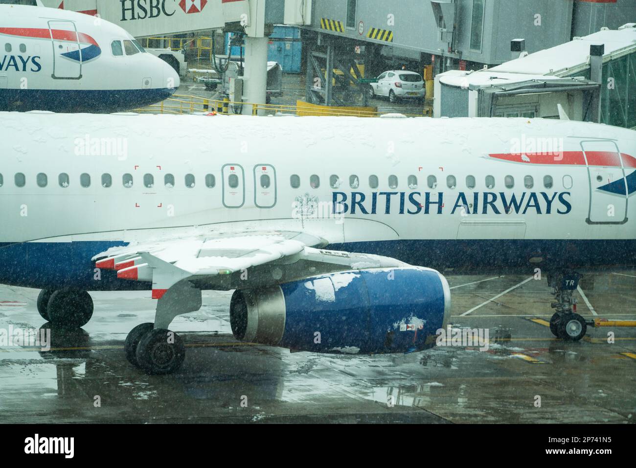 London, UK. 8 March 2023. Commercial airlines at the gates during heavy ...