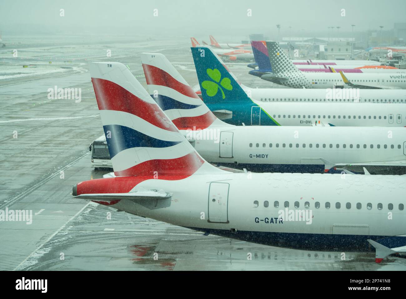 London, UK. 8 March 2023. Commercial airlines at the gates during heavy ...