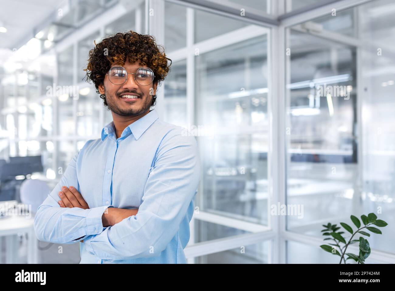 Portrait of young successful businessman inside modern office, hispanic ...