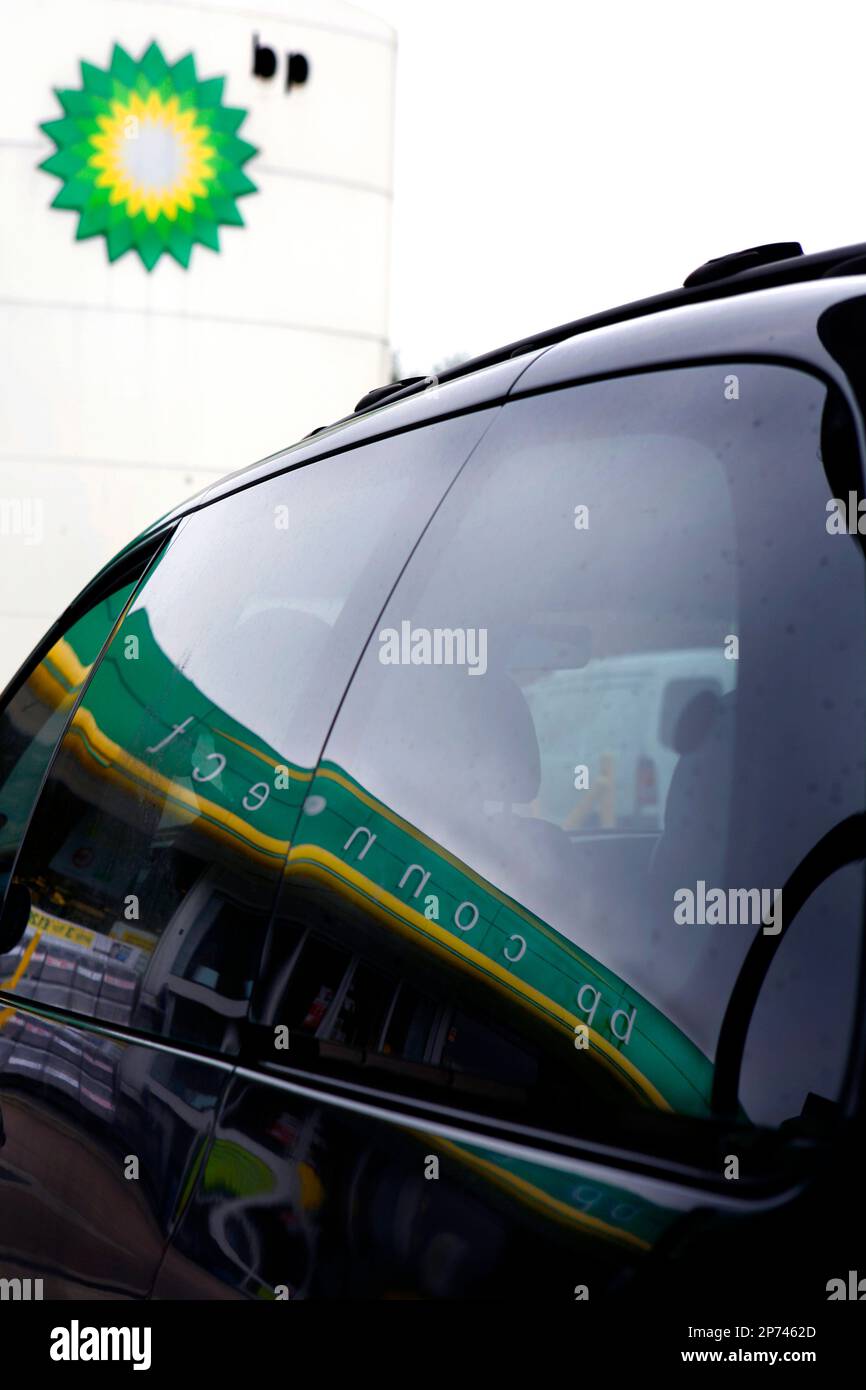 The BP logo at a petrol station with the BP Connect sign reflecting on ...