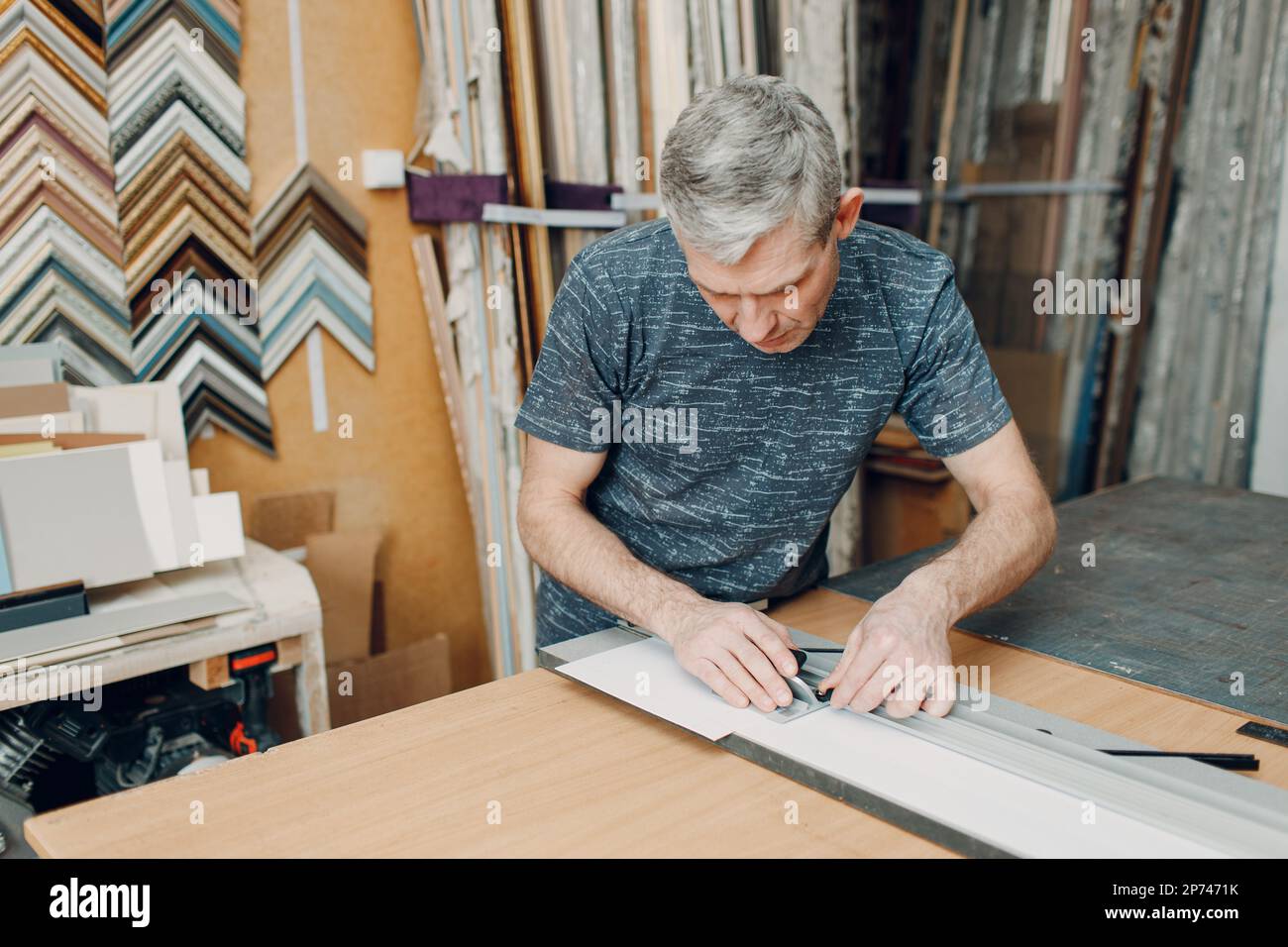 Framing Workshop cutting cardboard carton frame. Making baguette ...