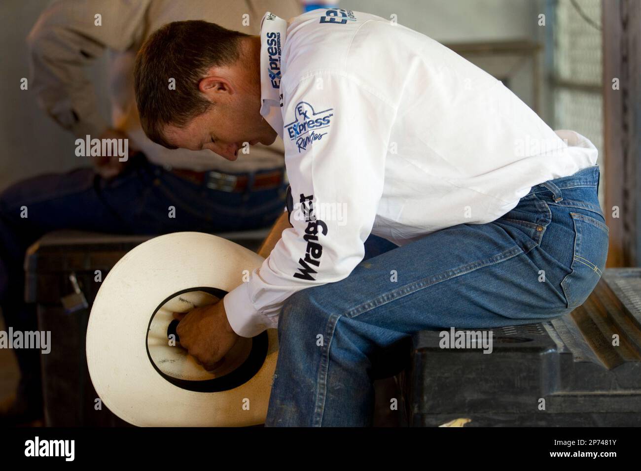 Bullrider Corey Navarre from Weatherford, Okla., prays behind the main ...